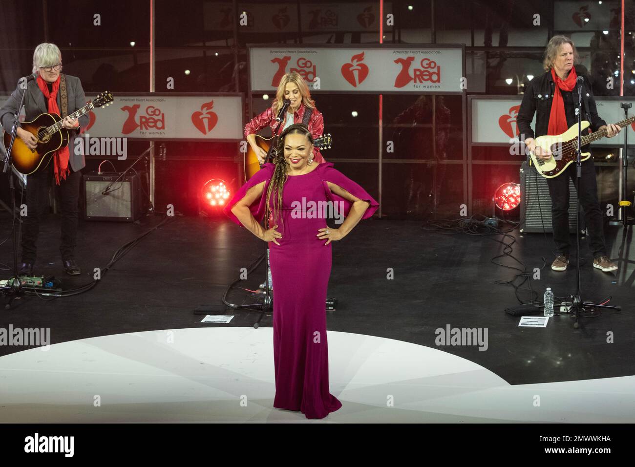 Tisha Campbell wearing dress by Alexander by Daymor walks on stage ...