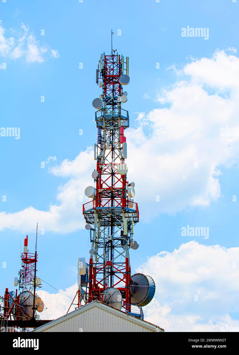 The cell tower with antenna against blue sky Stock Photo - Alamy
