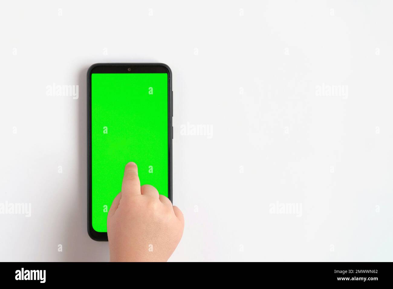 Child hand touching clicking on mobile phone with chromakey screen ...
