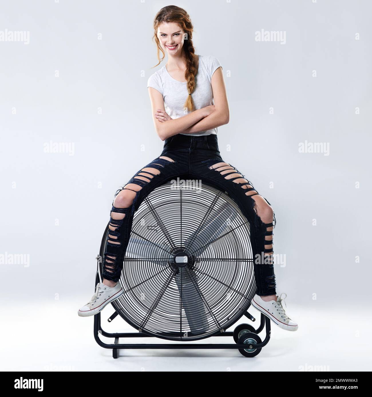 Shes fan-tastic. Studio portrait of an attractive young woman sitting ...