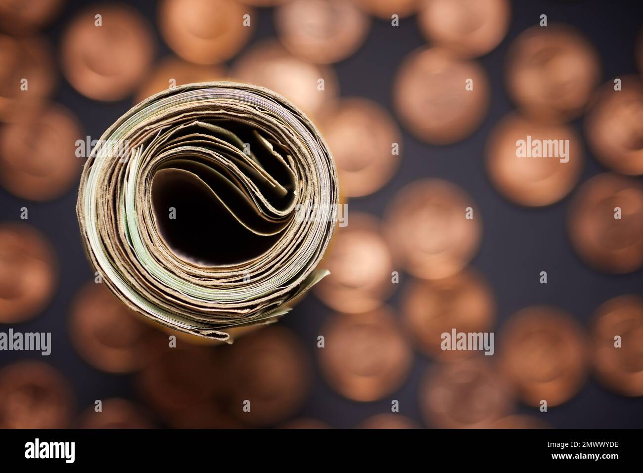 Banknotes rolled up with a rubber band on table Stock Photo - Alamy