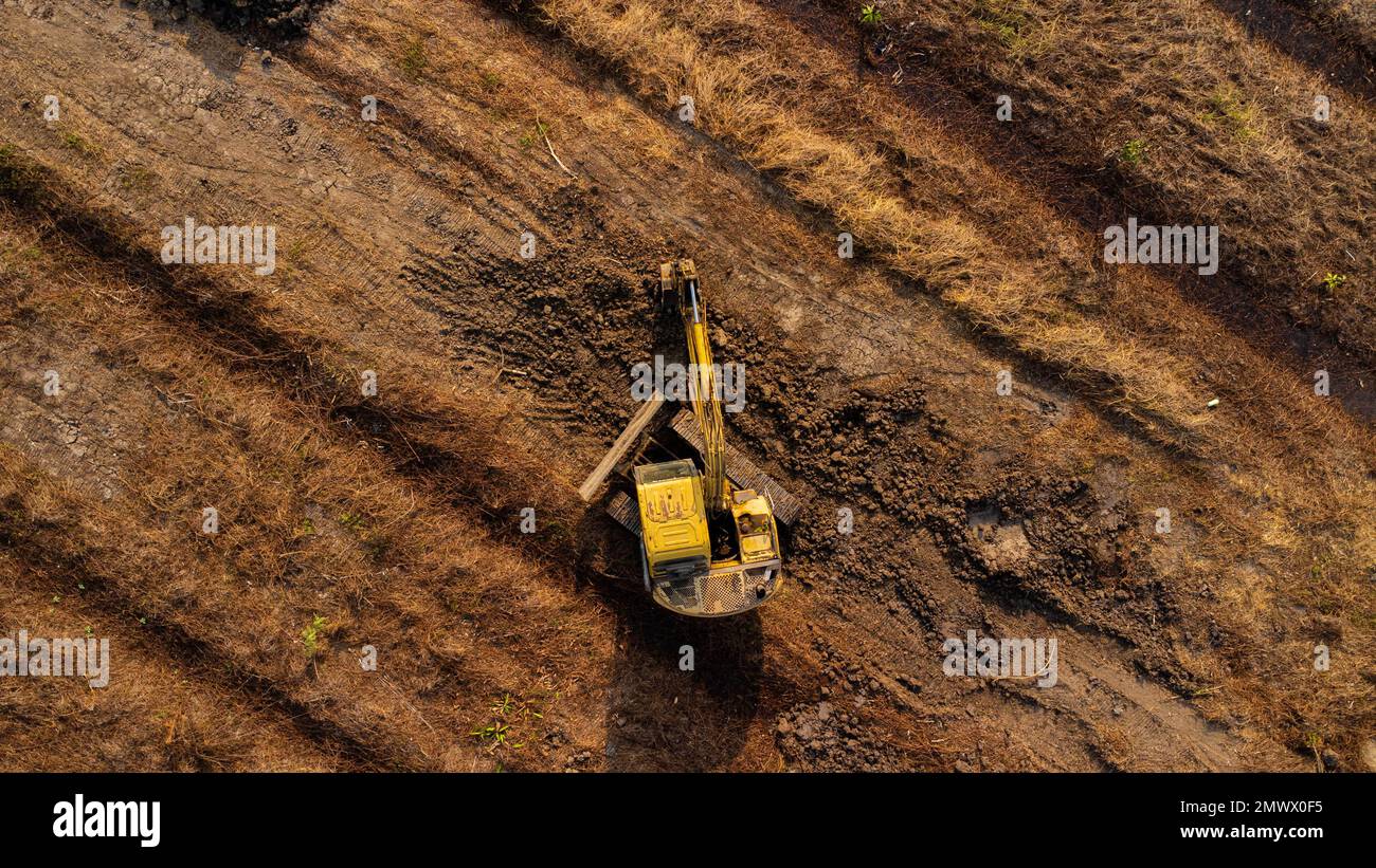 Aerial view of wheel loader excavator with backhoe unloading sand in ...