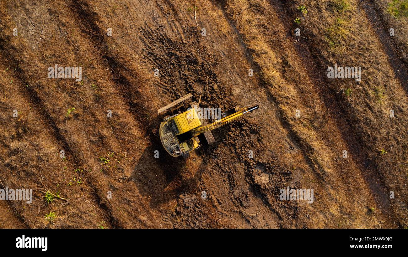 Aerial view of wheel loader excavator with backhoe unloading sand in ...