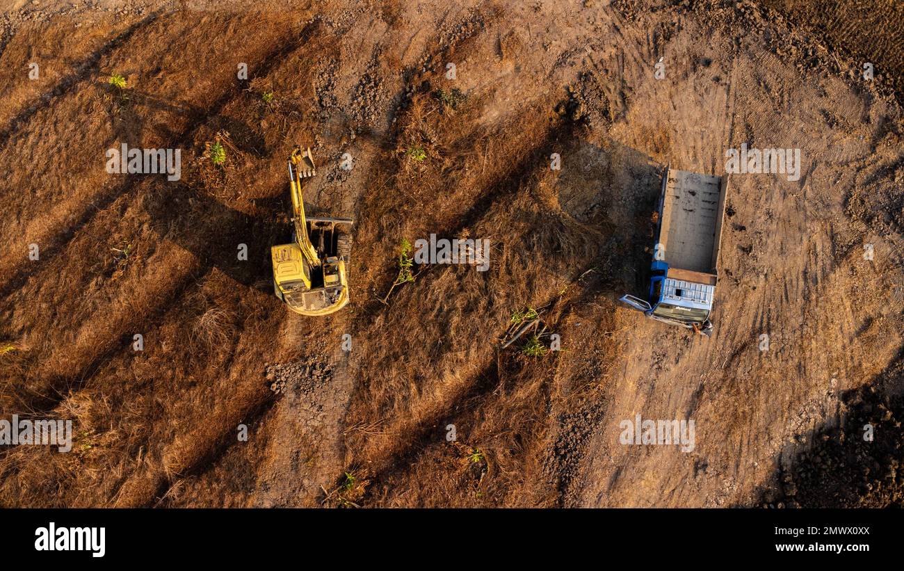 Aerial view of a wheel loader excavator with a backhoe loading sand ...