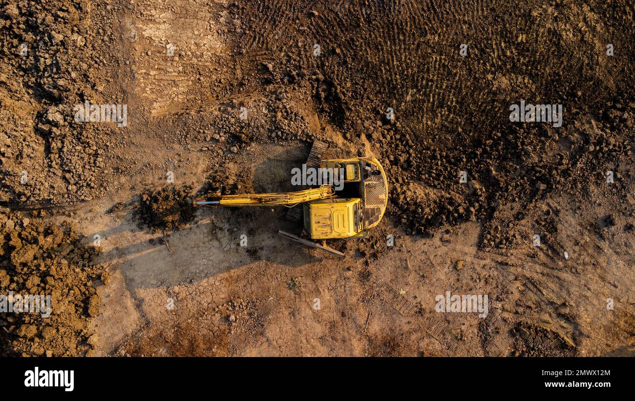 Aerial view of wheel loader excavator with backhoe unloading sand in ...