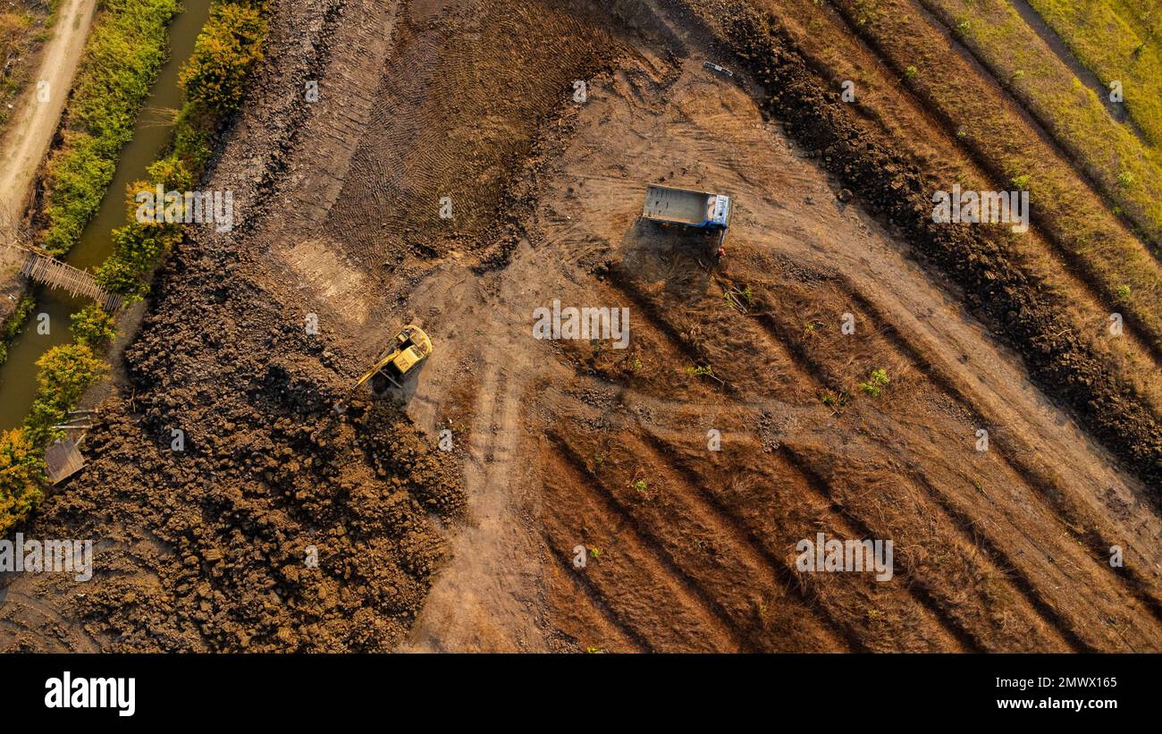 Aerial view of a wheel loader excavator with a backhoe loading sand ...