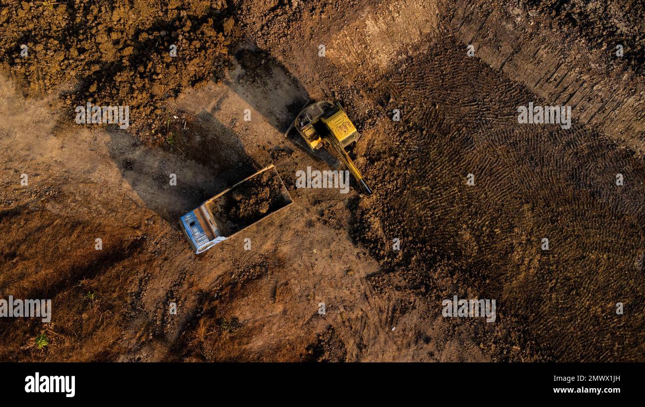 Aerial view of a wheel loader excavator with a backhoe loading sand ...