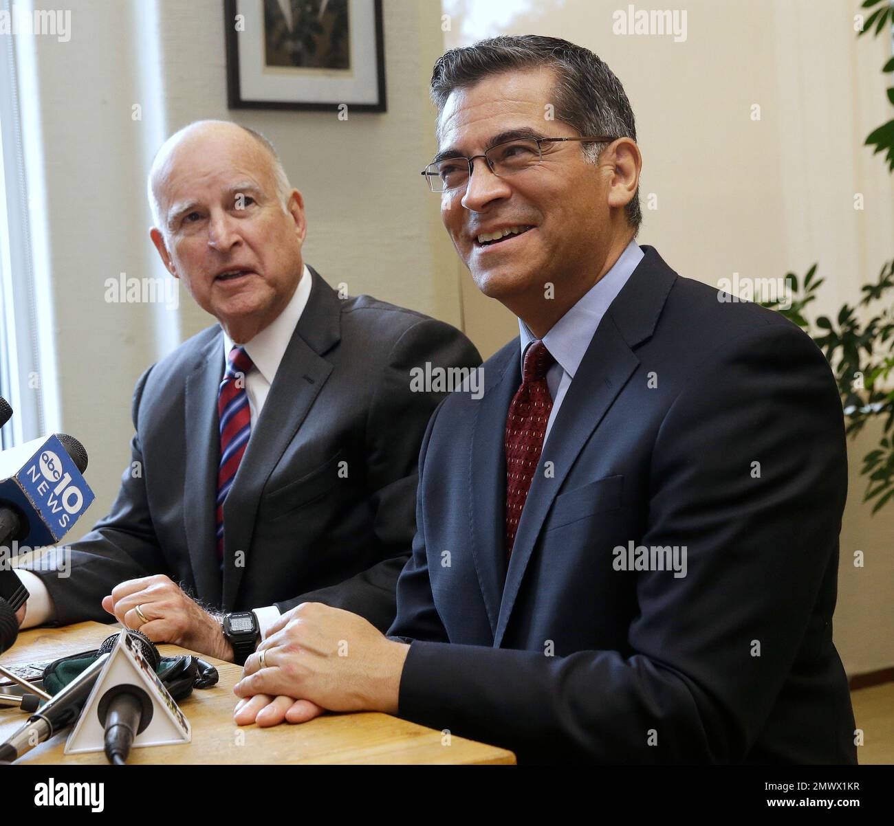 California Gov. Jerry Brown, left, answers a reporter's question during ...