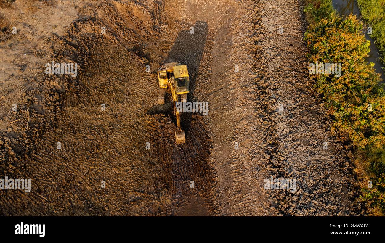 Aerial view of wheel loader excavator with backhoe unloading sand in ...