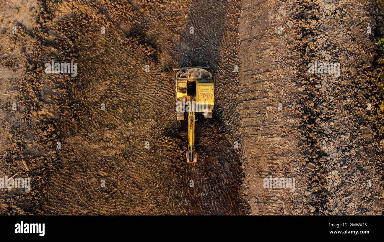 Aerial view of wheel loader excavator with backhoe unloading sand in ...