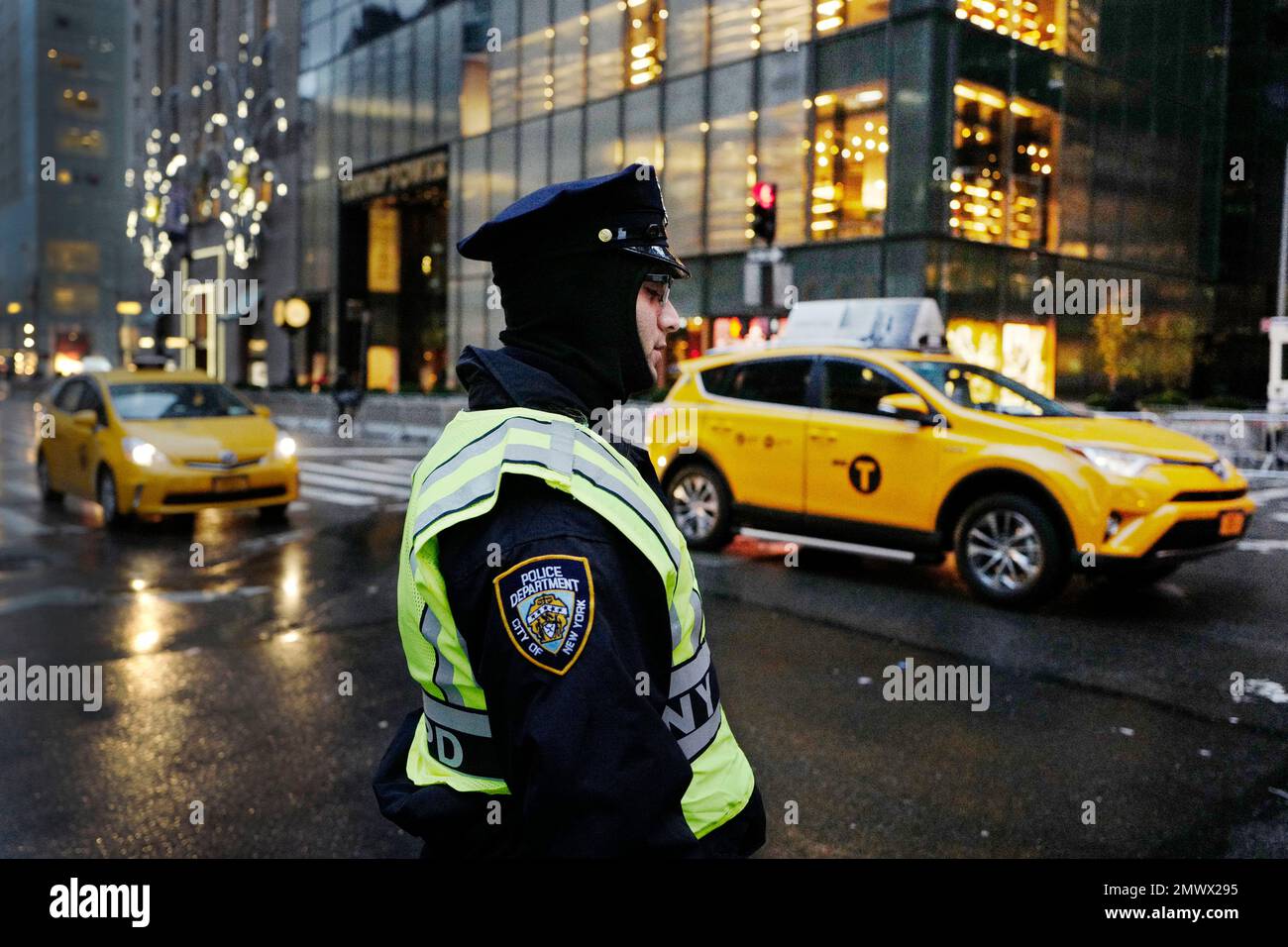 A New York City police officer stands watch outside Trump Tower, Monday ...