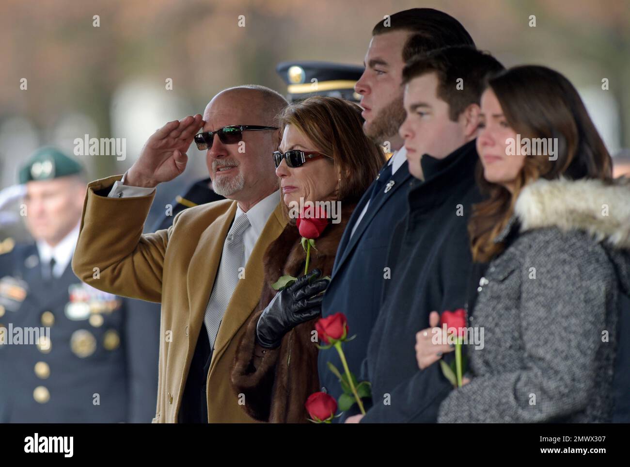 Brian McEnroe, left, and Linda Frost, second from left, listen to the ...