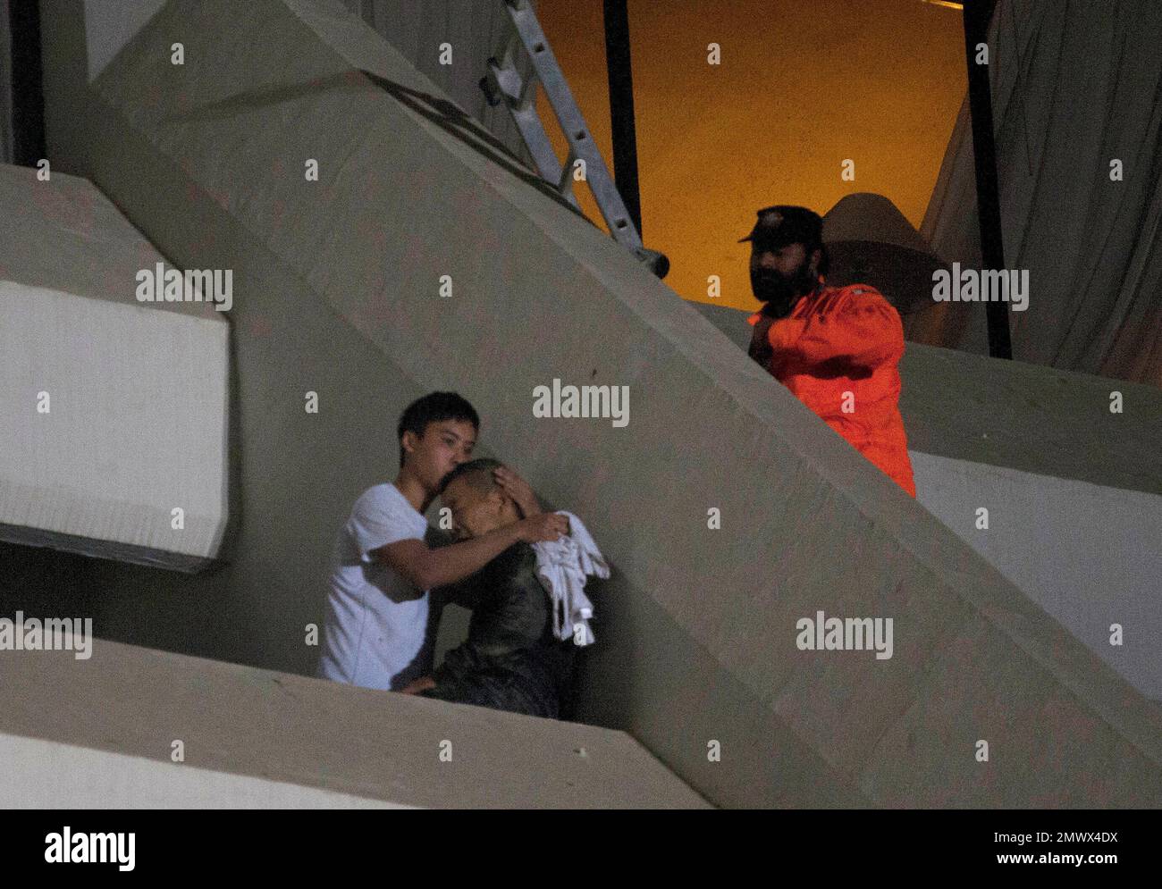 Foreigners wait for help at a hotel on fire in Karachi, Pakistan ...