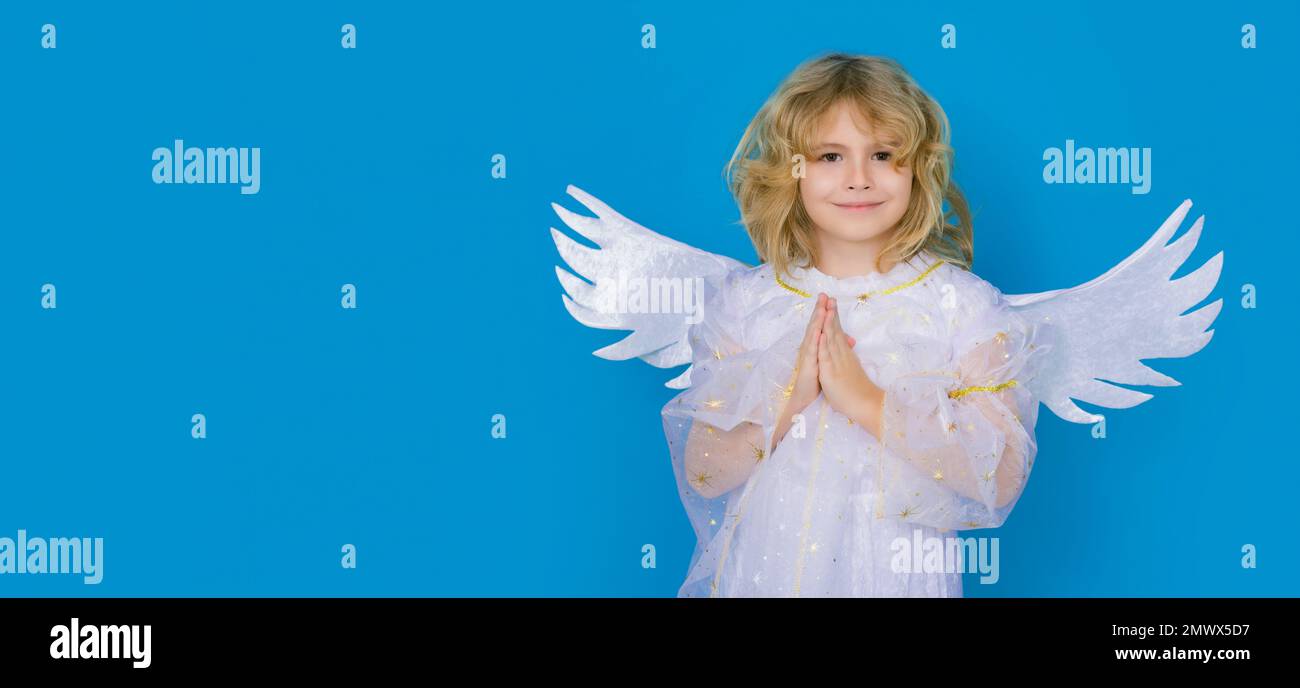 Valentine's day. Blonde cute child with angel wings with prayer hands ...