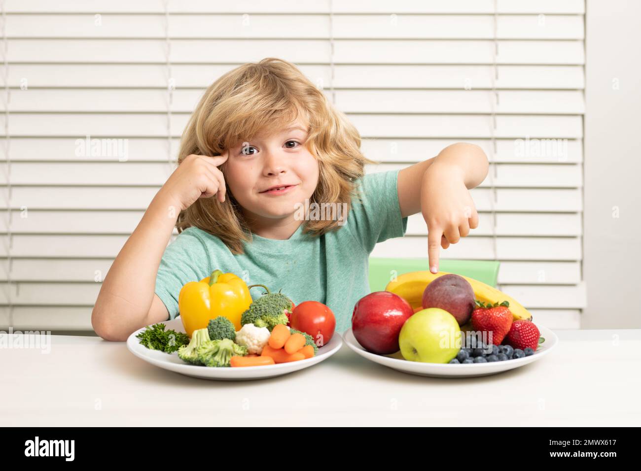 Fruits and vegetables. Portrait of preteen child eat fresh healthy food ...
