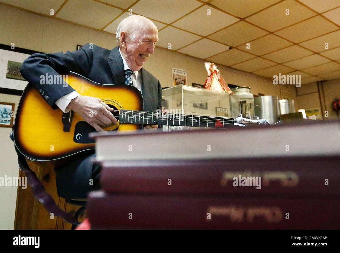 Pastor Al Johnson plays a guitar that survived a tornado that occurred ...
