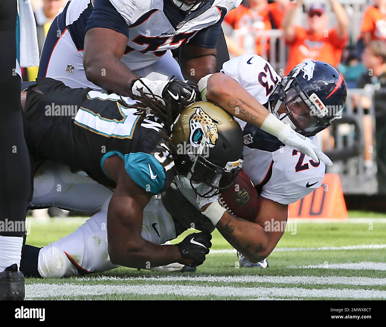 Denver Broncos running back Devontae Booker (23) scores a touchdown past Jacksonville Jaguars ...