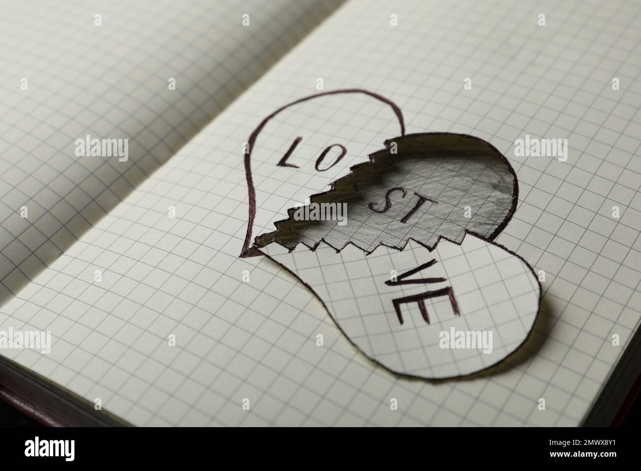 Broken heart with words LOVE and LOST in notebook, closeup ...