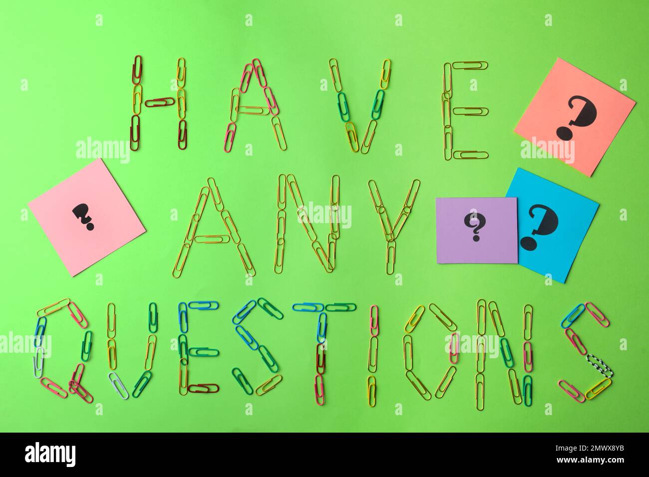 Phrase HAVE ANY QUESTIONS with paperclips and query marks on green ...