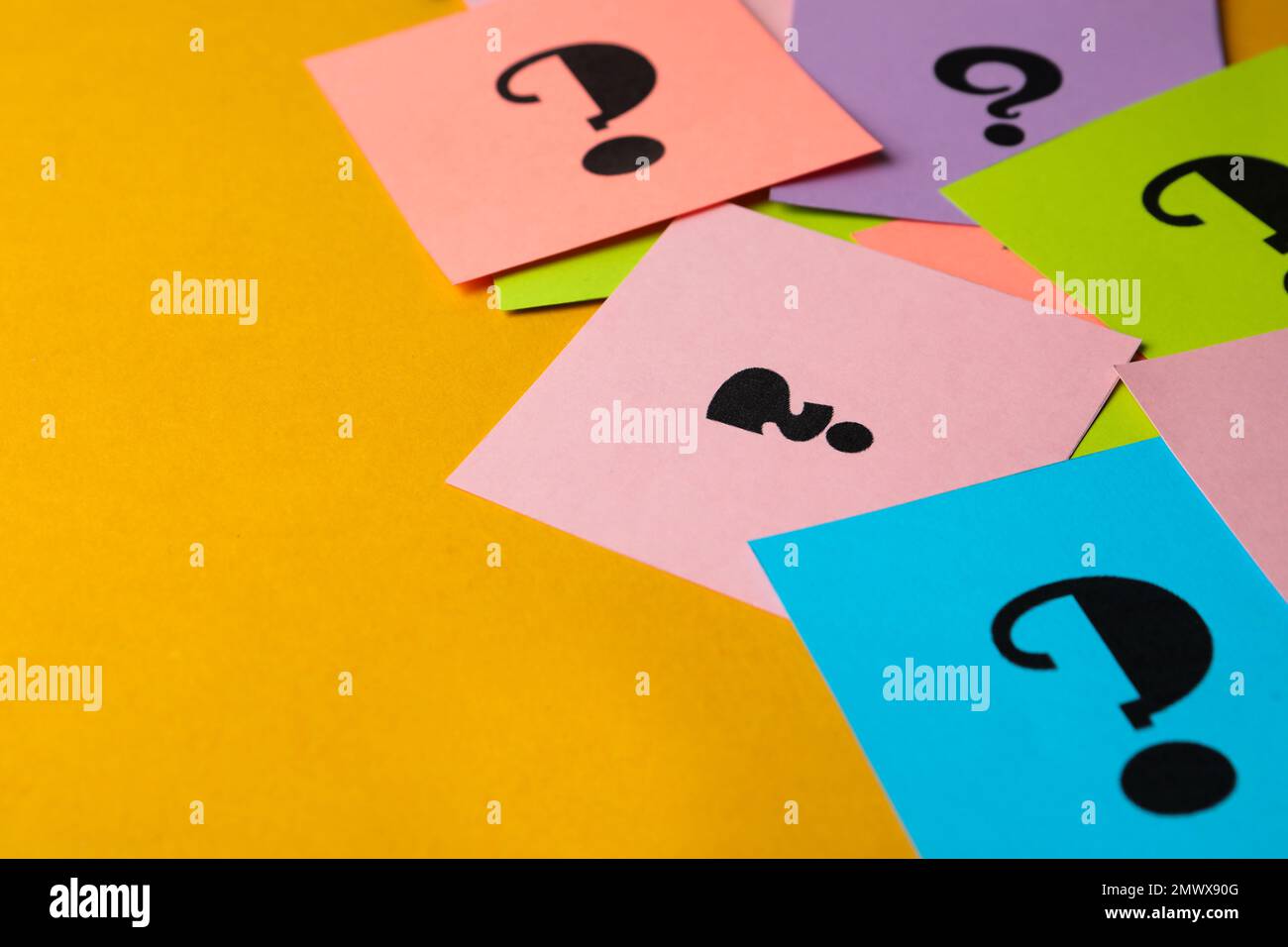 Paper cards with question marks on yellow background, closeup Stock ...