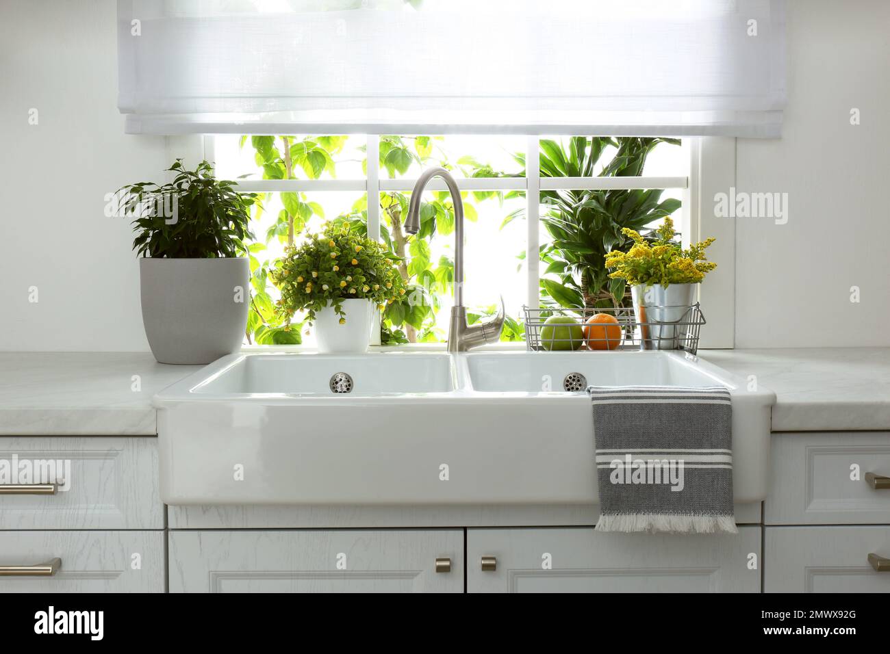 Beautiful white sink near window in modern kitchen Stock Photo - Alamy