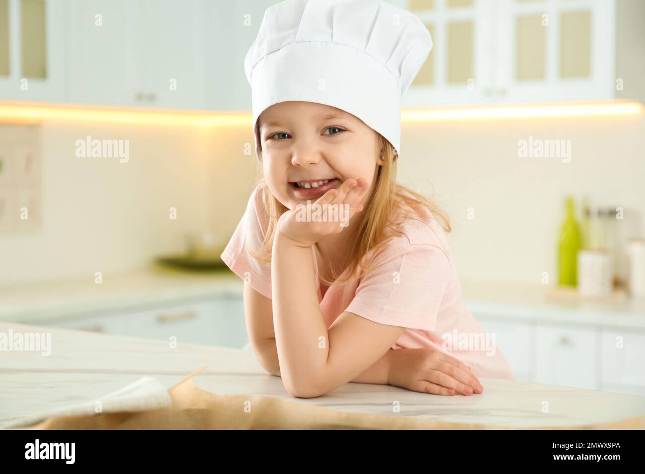 Portrait of cute little girl wearing chef hat in kitchen Stock Photo ...