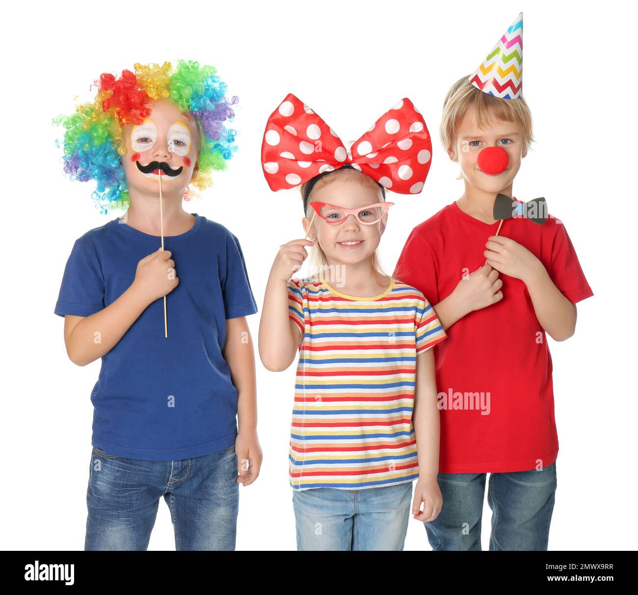 Cute children in funny costumes on white background. April fool's day ...
