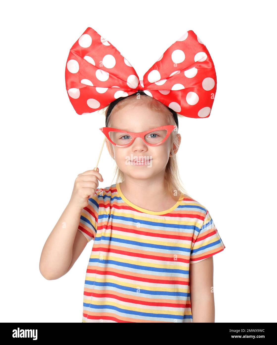 Little girl with large bow and funny glasses on white background. April ...