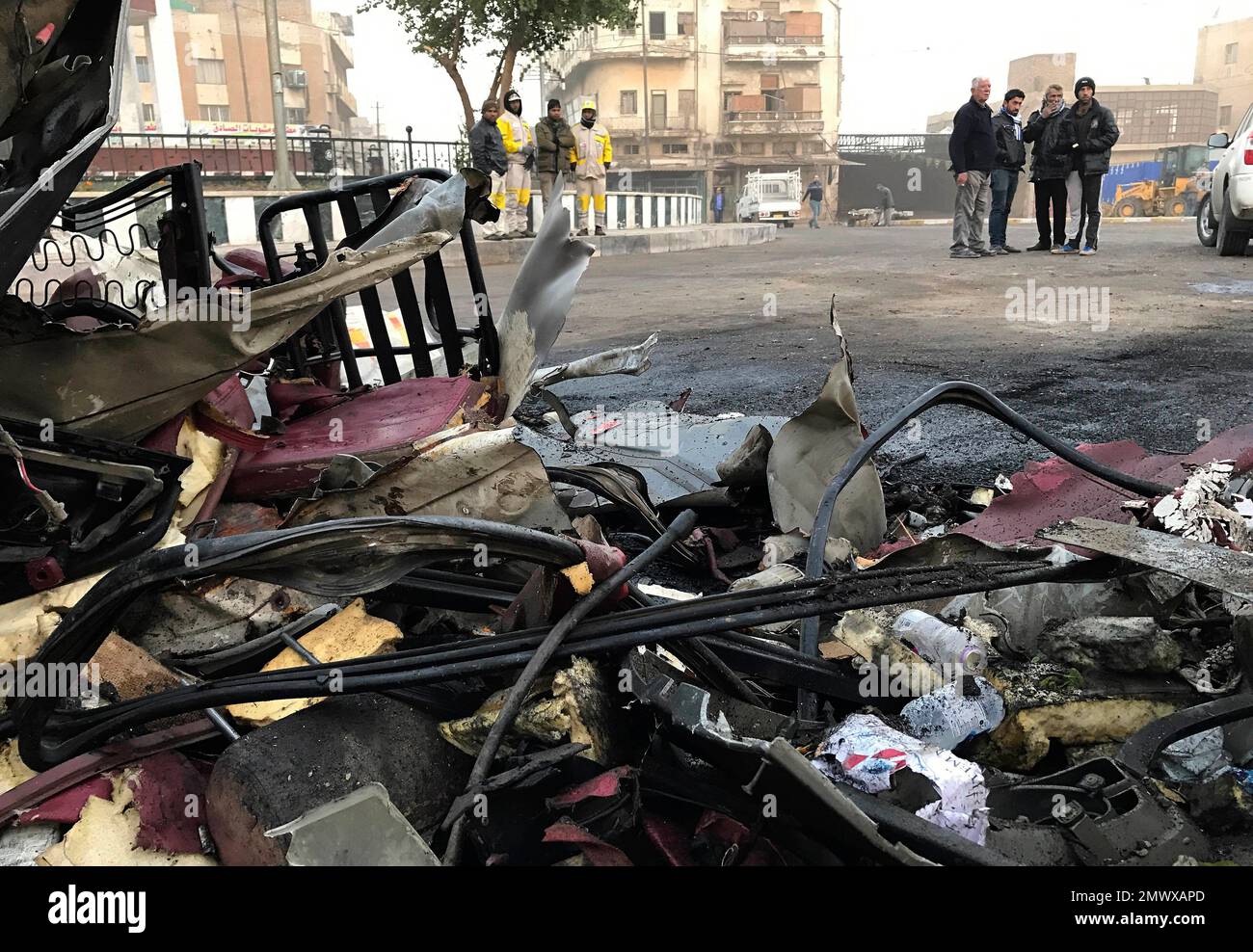 People inspect the aftermath of a car bomb in Baghdad, Iraq, Sunday ...