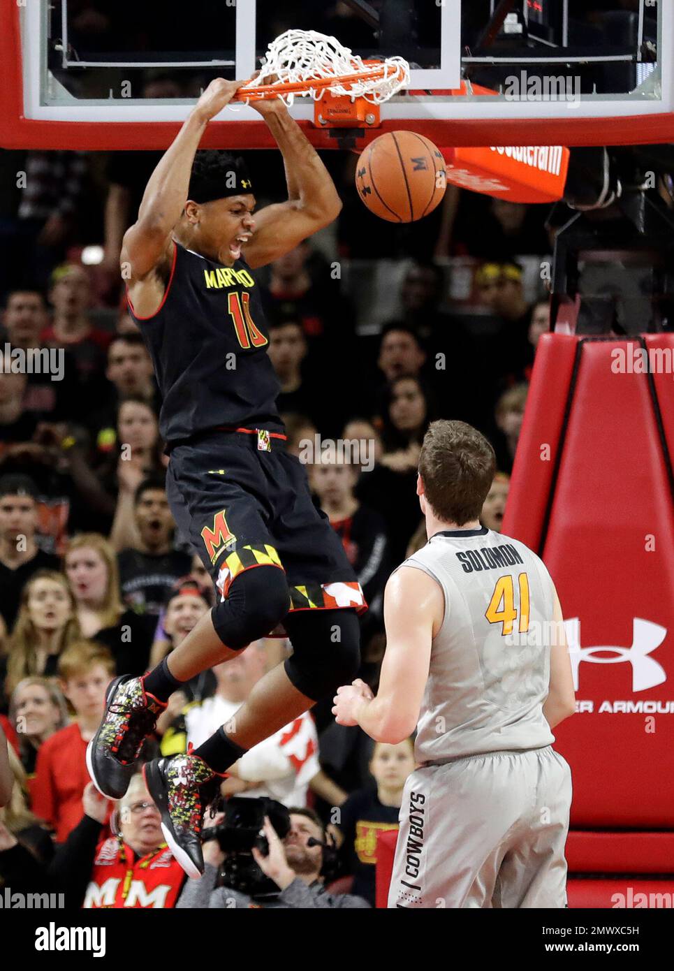 Maryland forward L.G. Gill, top, dunks on Oklahoma State forward ...