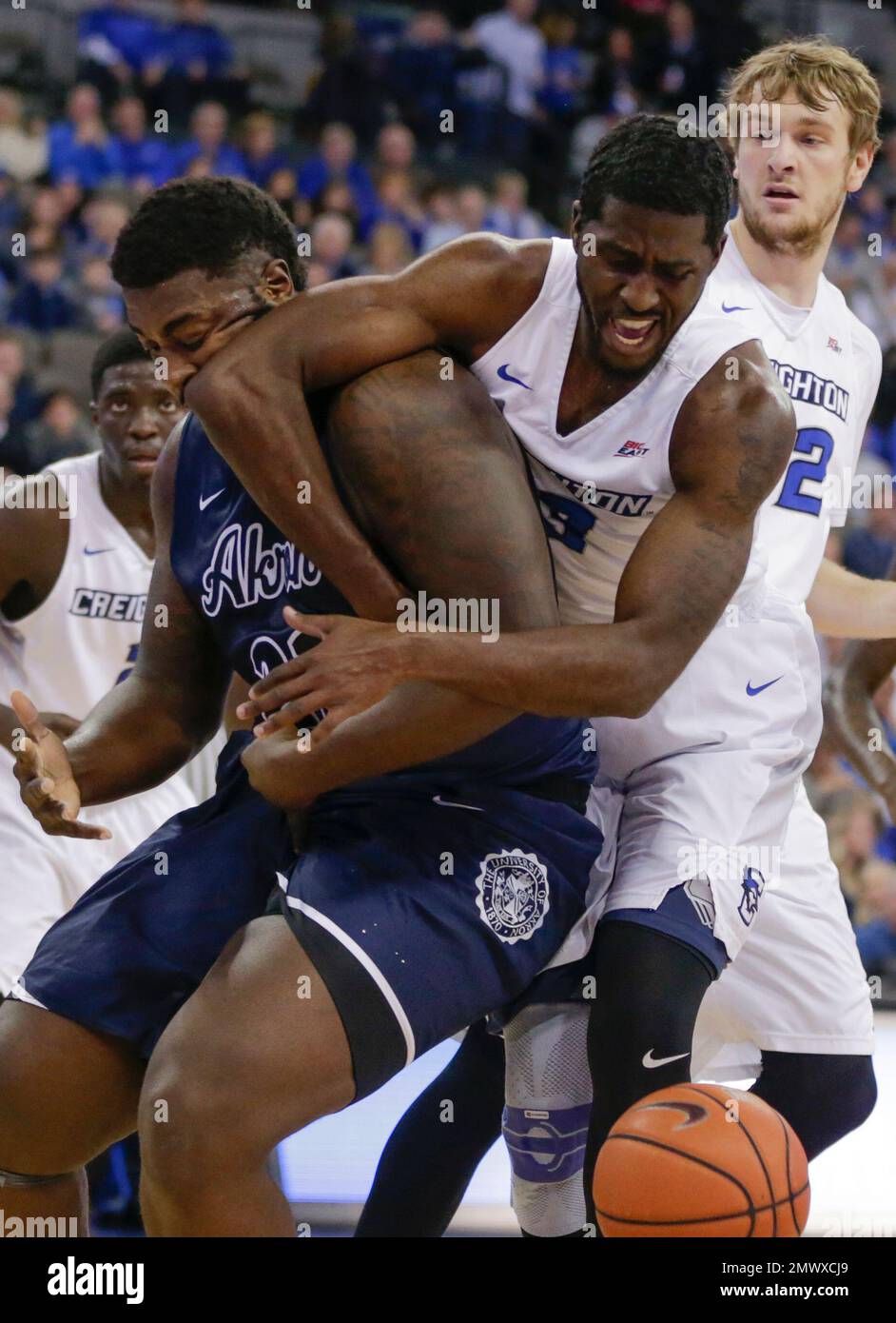 Akron's Isaiah Johnson, left, and Creighton's Cole Huff (13) struggle ...