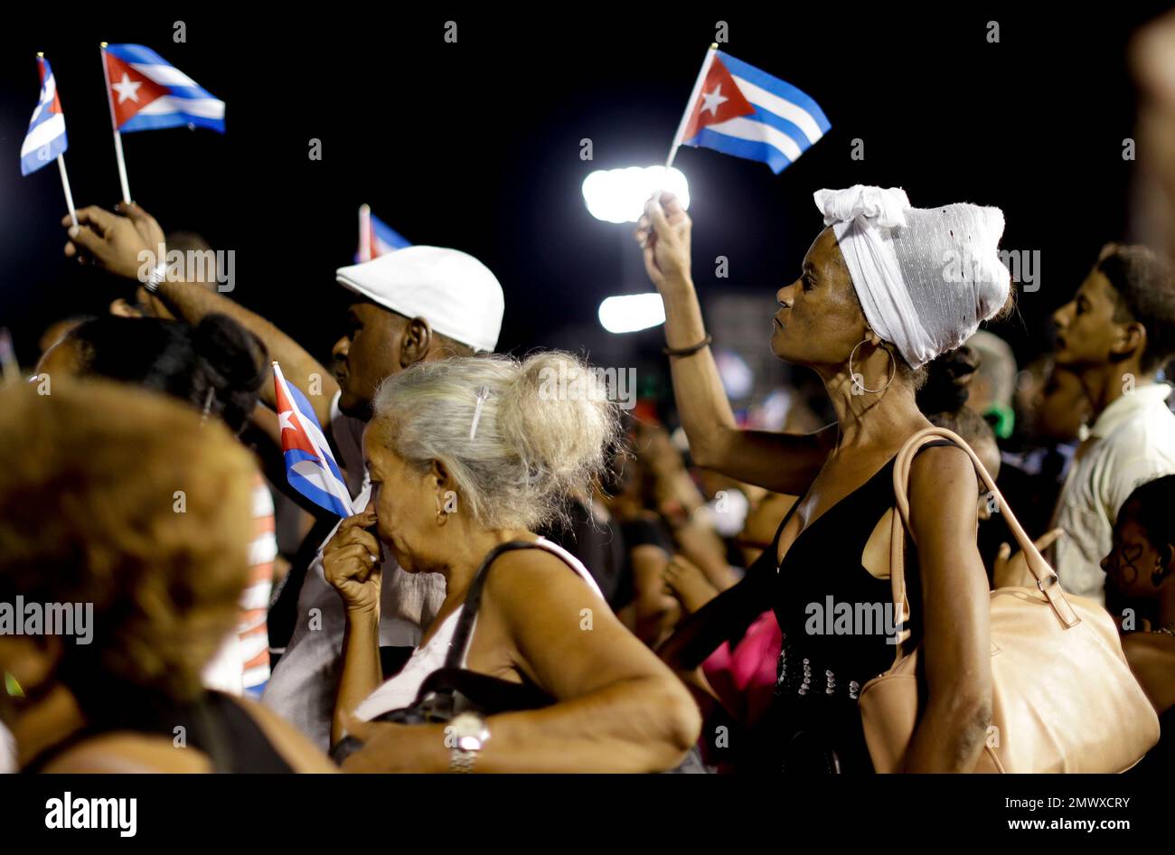 People wave Cuban flags during a rally in honor of late Cuban leader ...