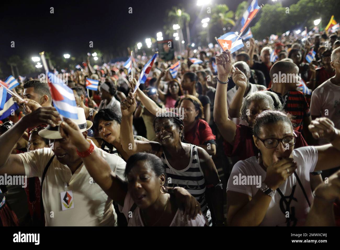 People wave Cuban flags during a rally in honor of late Cuban leader ...