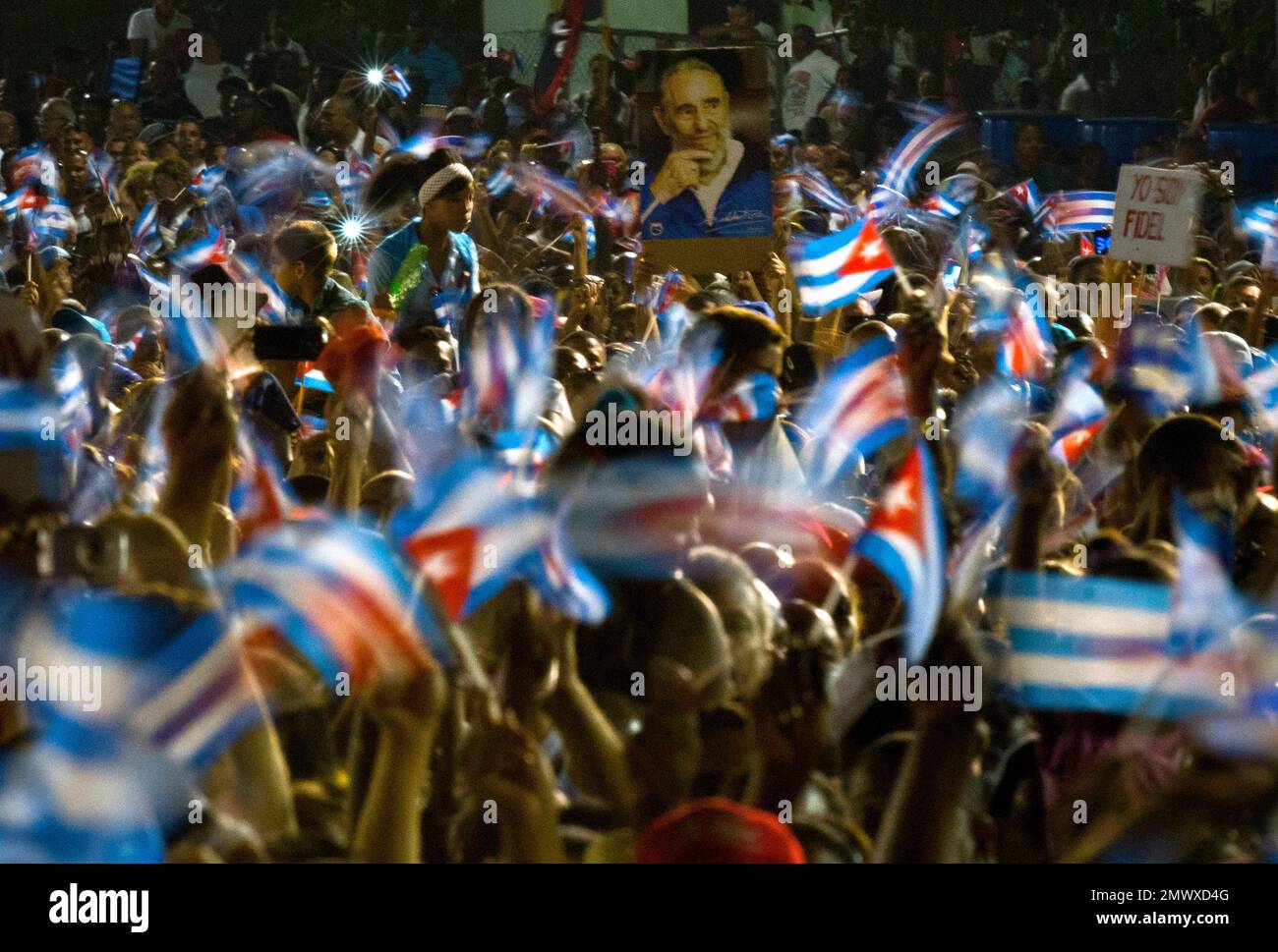 People wave Cuban flags during a rally honoring Cuba's late leader ...