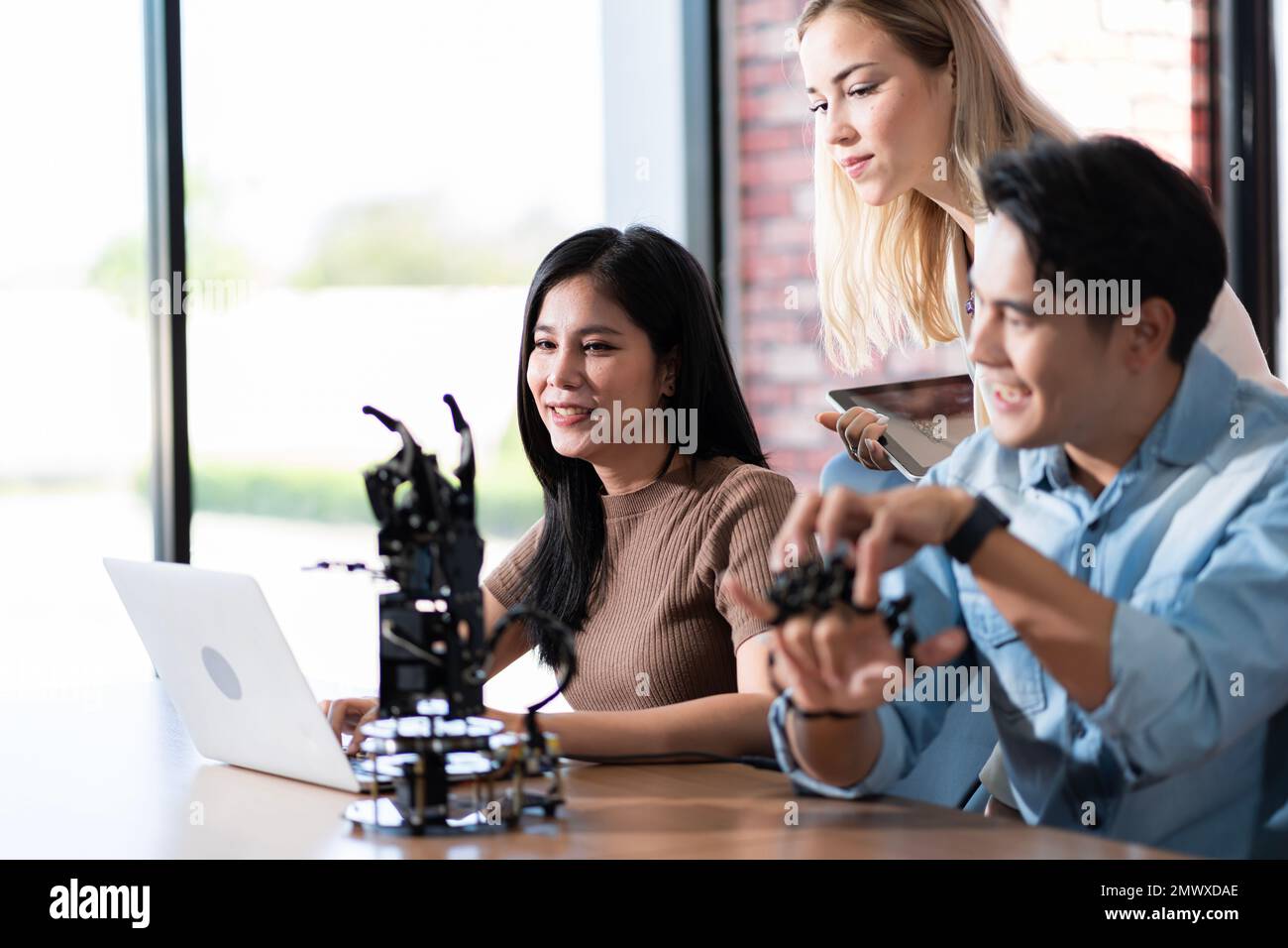 Young students researching inventions with modern technology in ...