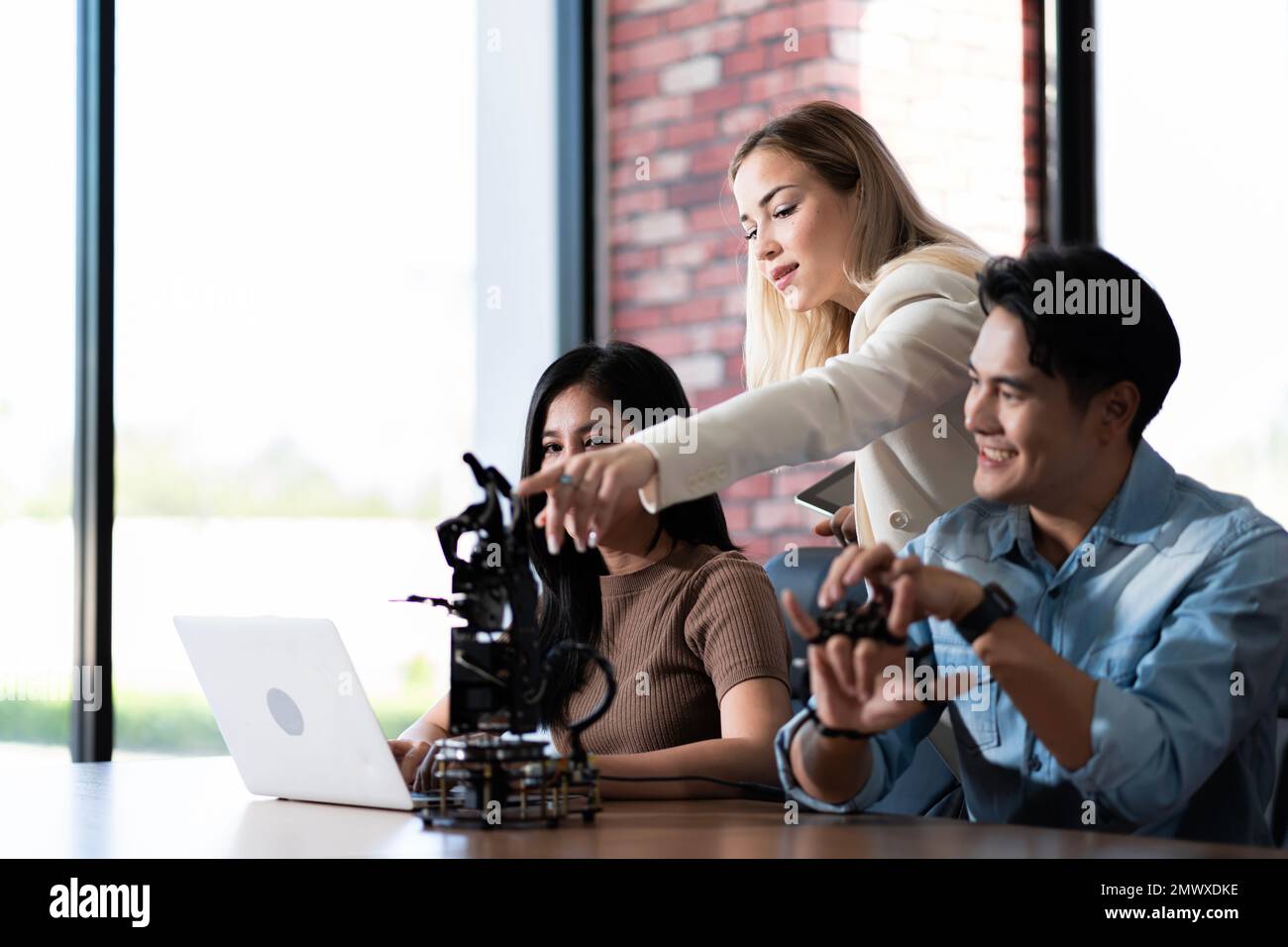 Young students researching inventions with modern technology in ...