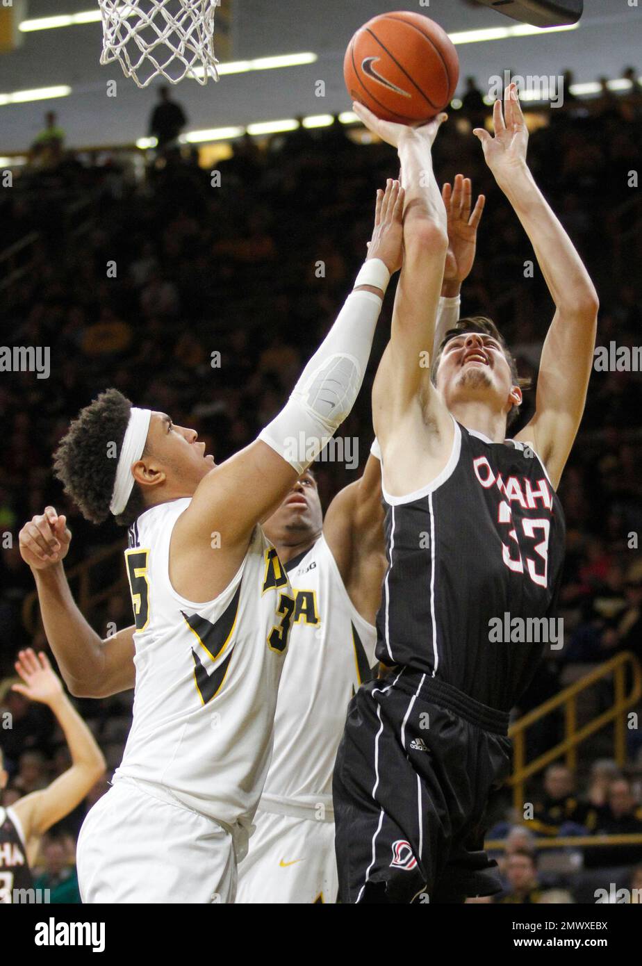 Omaha's Zach Pirog (33) goes to the basket against Iowa's Ahmad Wagner ...