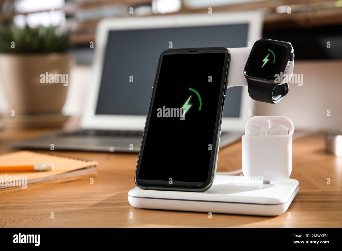 Mobile phone, earphones and smartwatch charging with wireless pad on ...
