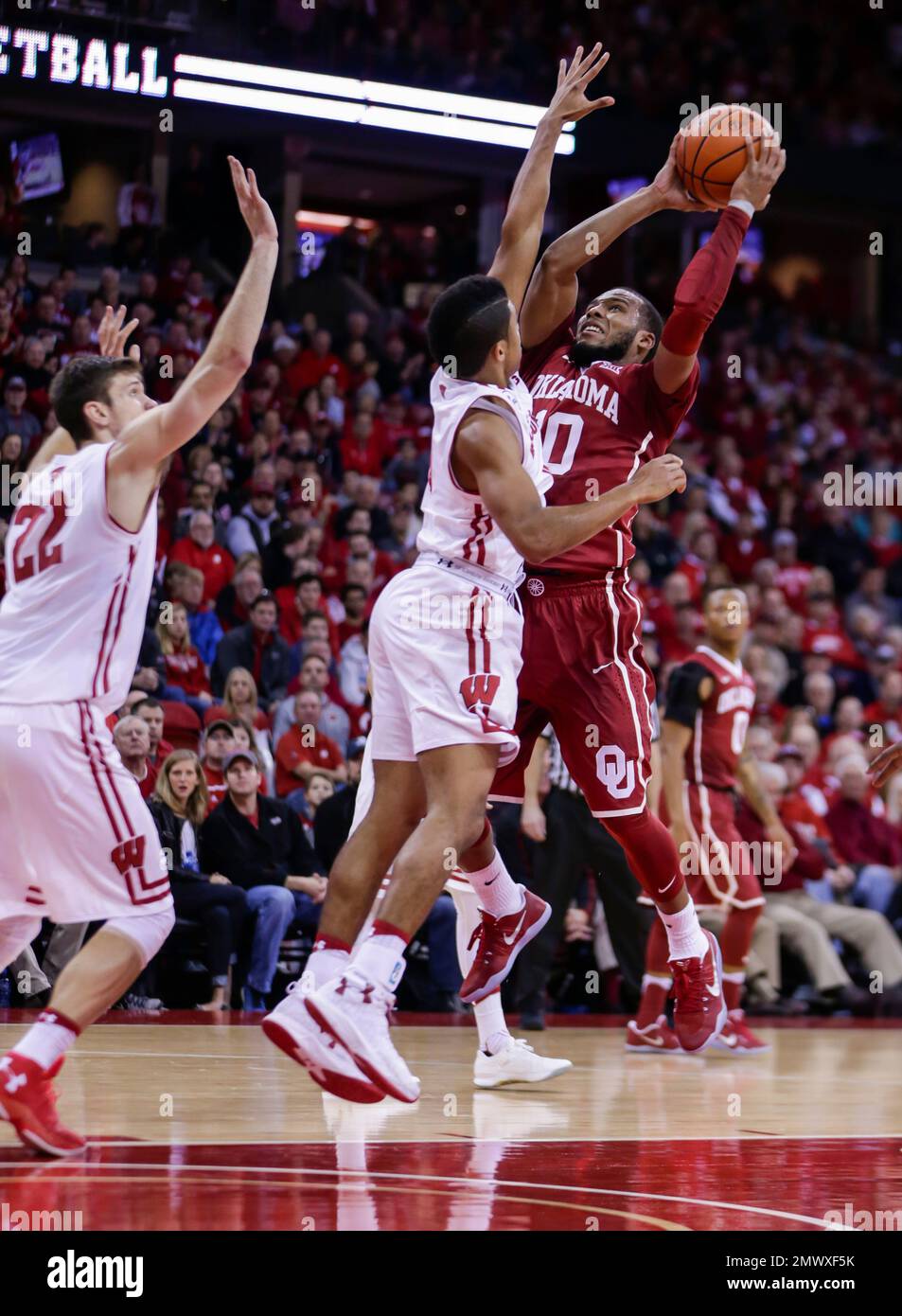 Oklahoma's Jordan Woodard (10) shoots against Wisconsin's D'Mitrik ...