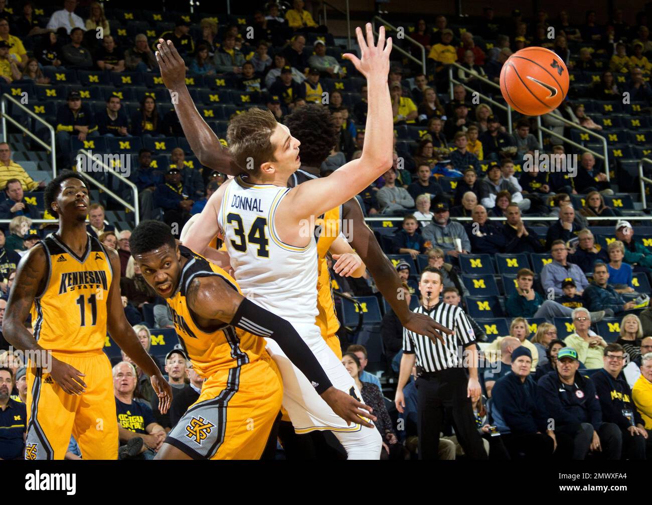 Kennesaw State guard Kendrick Ray, bottom, collides with Michigan ...