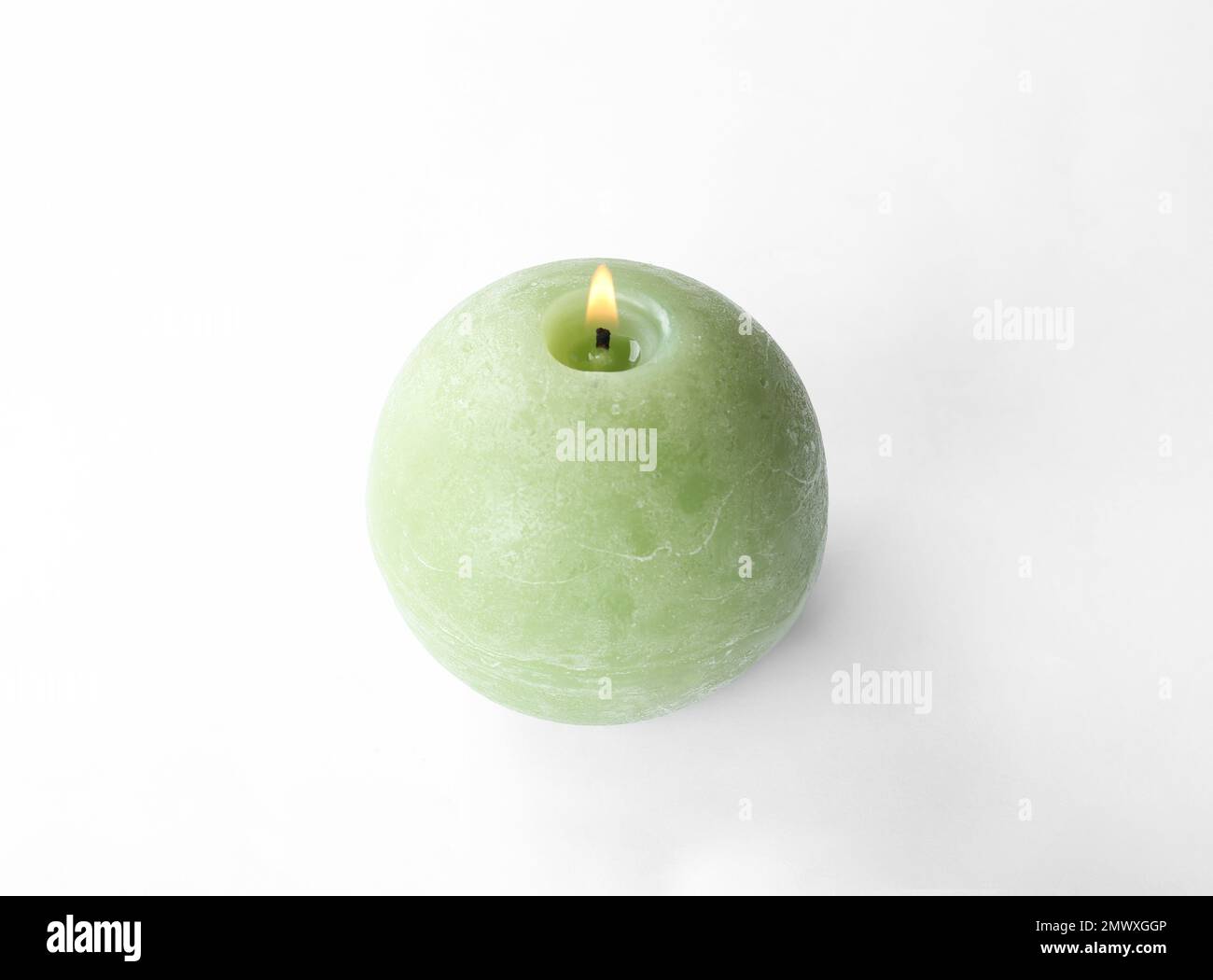 Small burning green candle isolated on white Stock Photo - Alamy