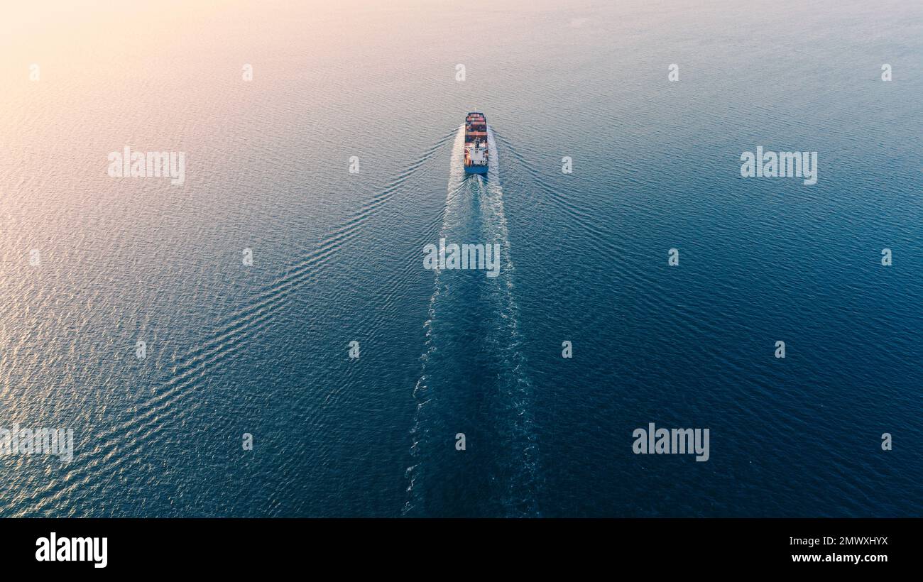 Stern of Cargo Container ship with contrail in the ocean ship carrying ...