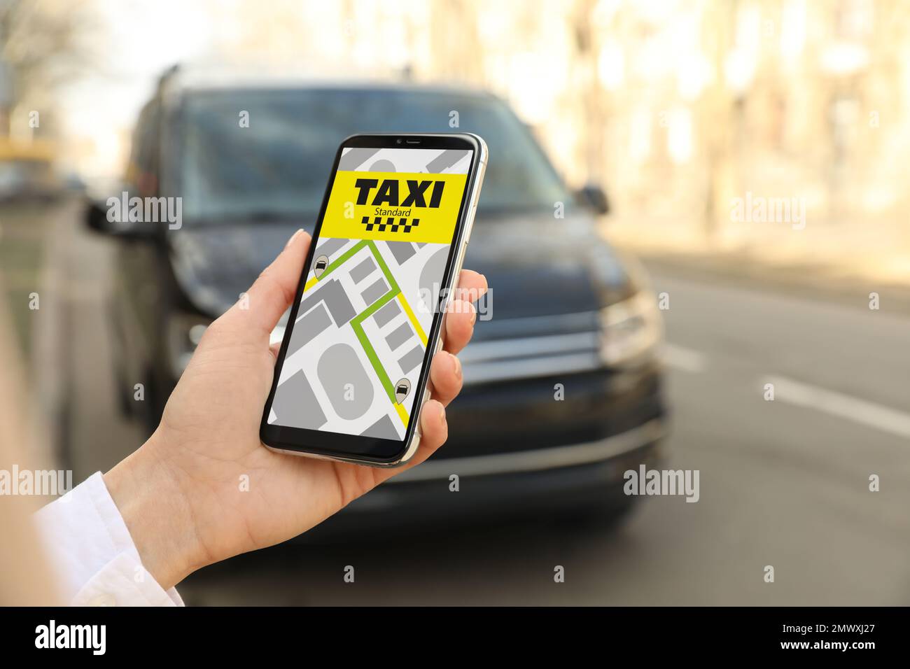 Woman ordering taxi with smartphone on city street, closeup Stock Photo - Alamy