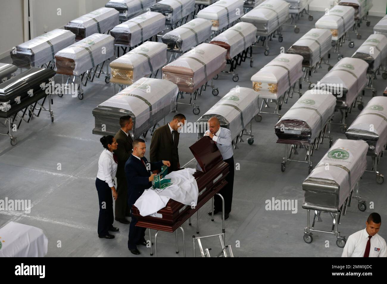 Funeral employees cover a casket, decorated with a Chapecoense soccer ...