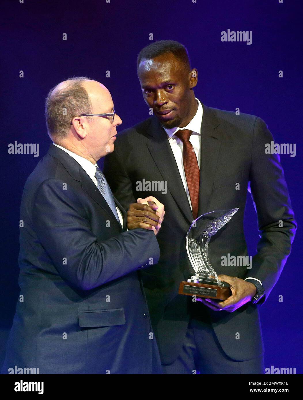 Prince Albert II of Monaco, left, shakes hands with Jamaican sprinter ...