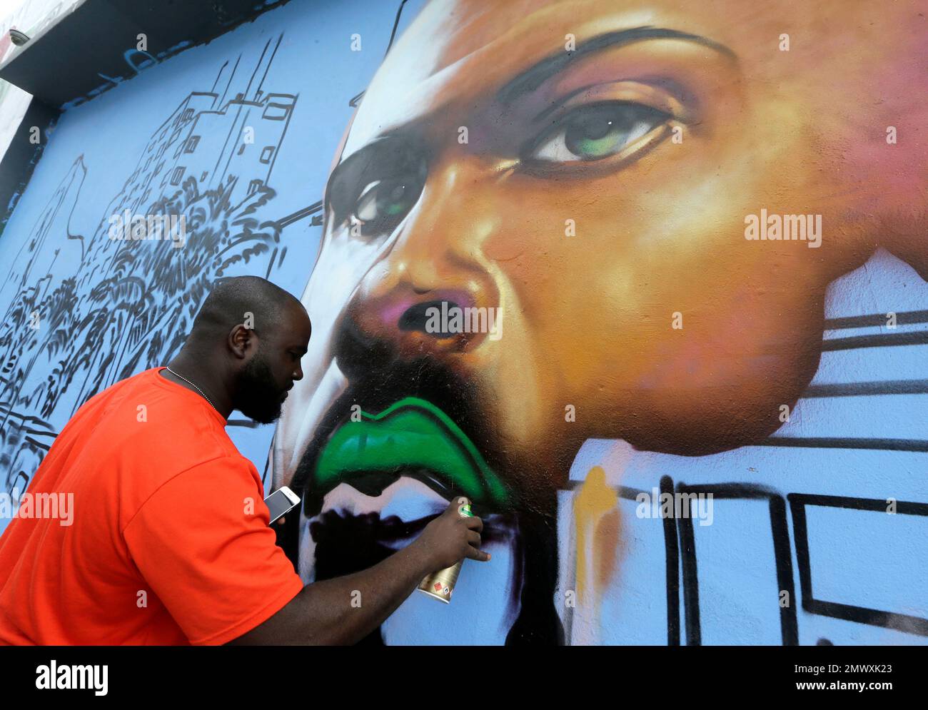 Artist Max Sansing, of Chicago, Ill., works on a mural, Friday, Dec. 2 ...