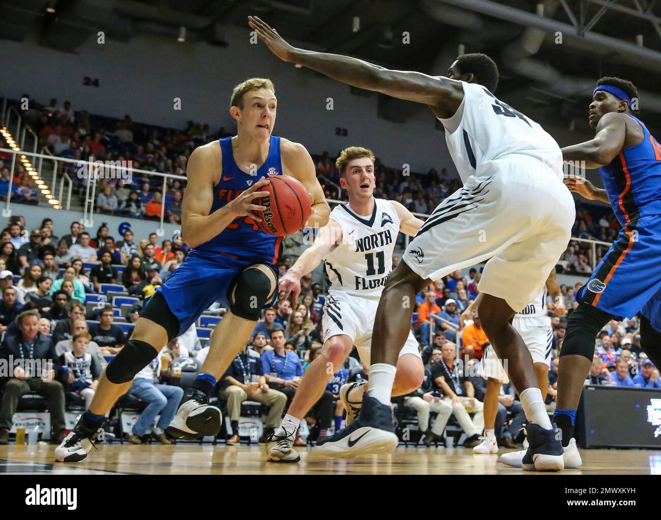 Florida guard Canyon Barry (24) drives to the basket chased by North ...