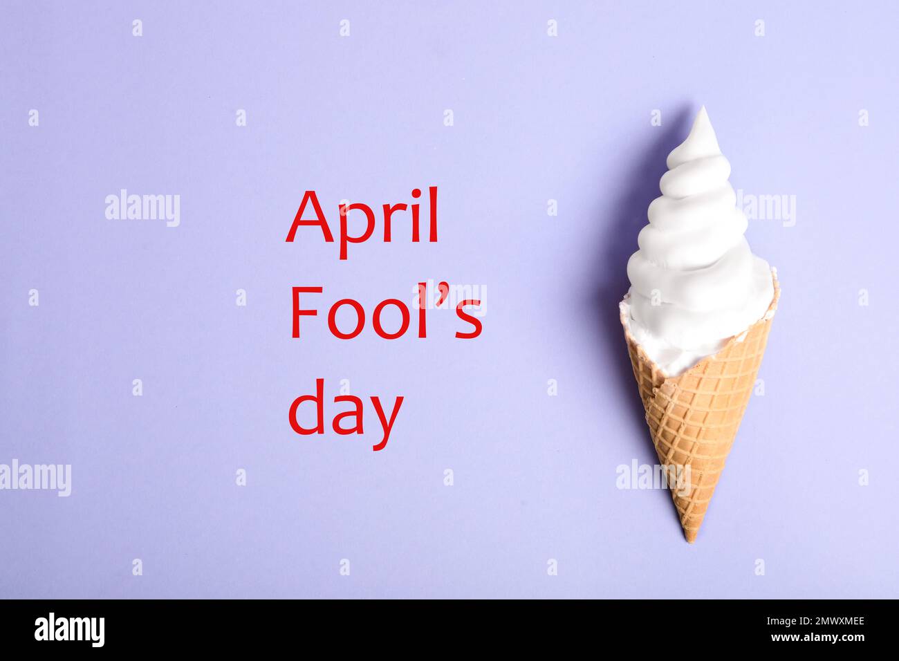 Top view of ice cream cone with shaving foam on violet background ...