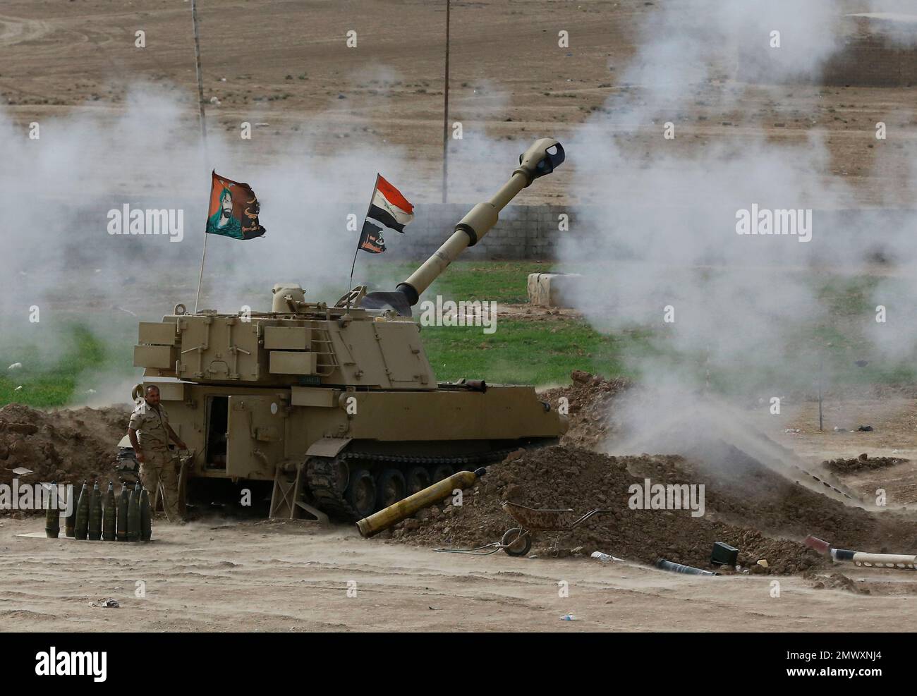 In this Tuesday, Nov. 15, 2016 photo, Iraqi soldiers fire a shell from ...