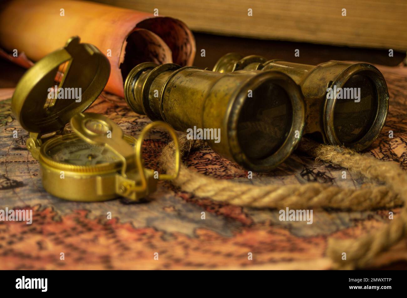 Antique adventure scroll background on adventurer table. Binoculars ...